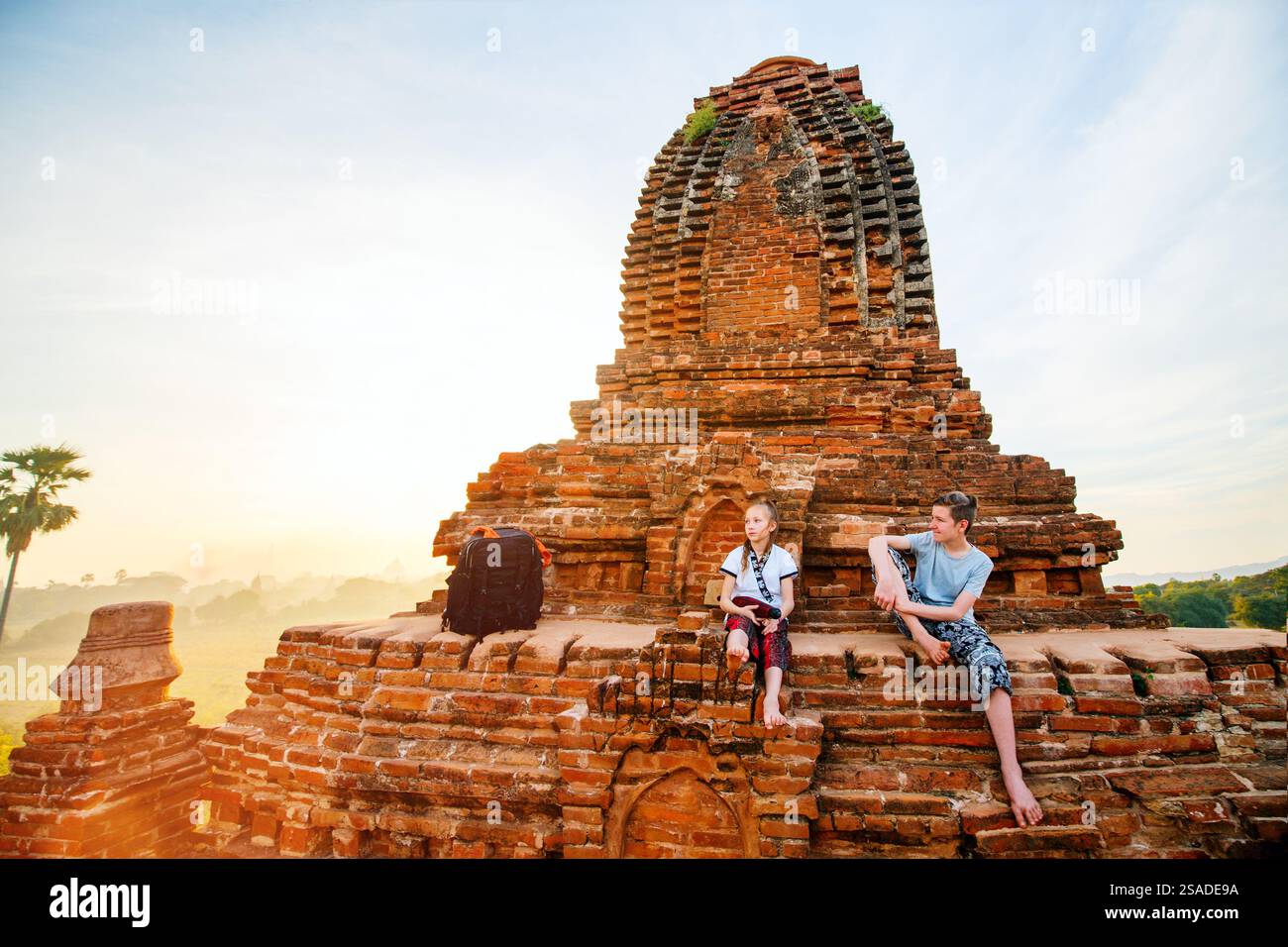 Kids brother and sister enjoying rooftop sunset view over Old Bagan in ...