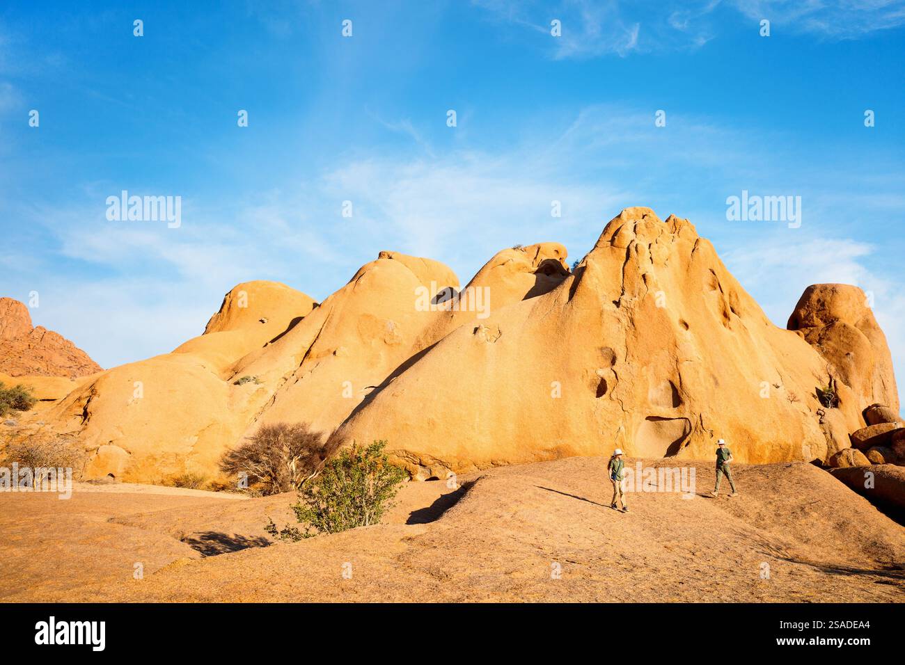 Kids brother and sister hiking in Spitzkoppe with unique rock ...