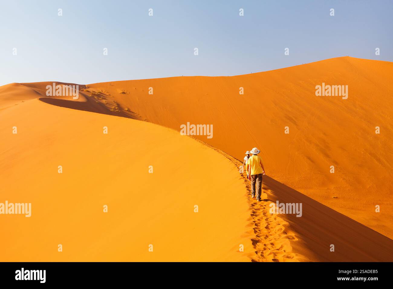 Kids brother and sister climbing up famous red sand dune Big Daddy in ...