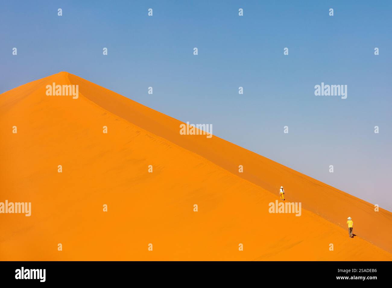 Kids brother and sister climbing up famous red sand dune Big Daddy in ...