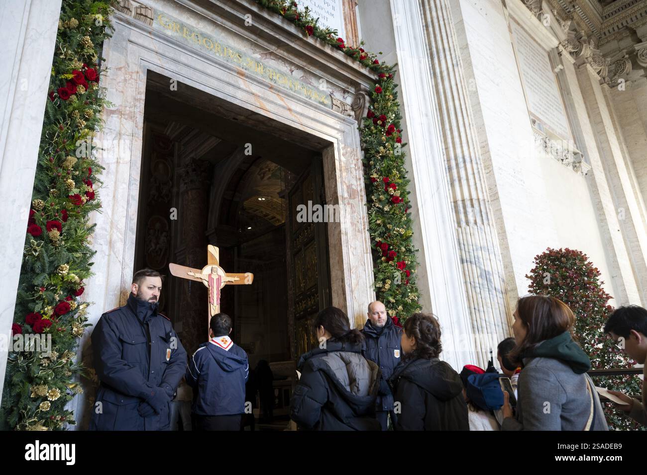 Pilgrims pass through the Holy Door of St. Peter's Basilica during the ...