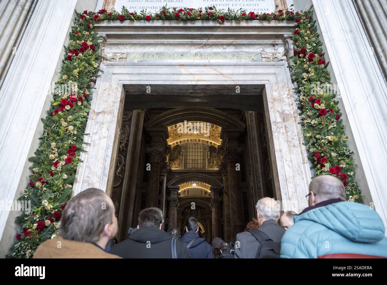 Pilgrims pass through the Holy Door of St. Peter's Basilica during the ...