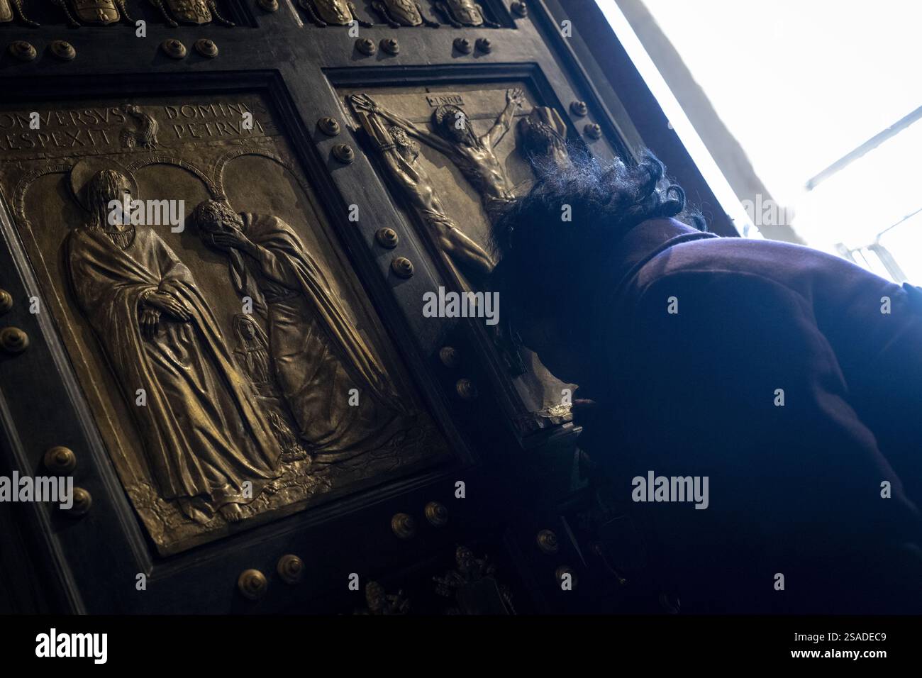 Pilgrims pass through the Holy Door of St. Peter's Basilica during the ...