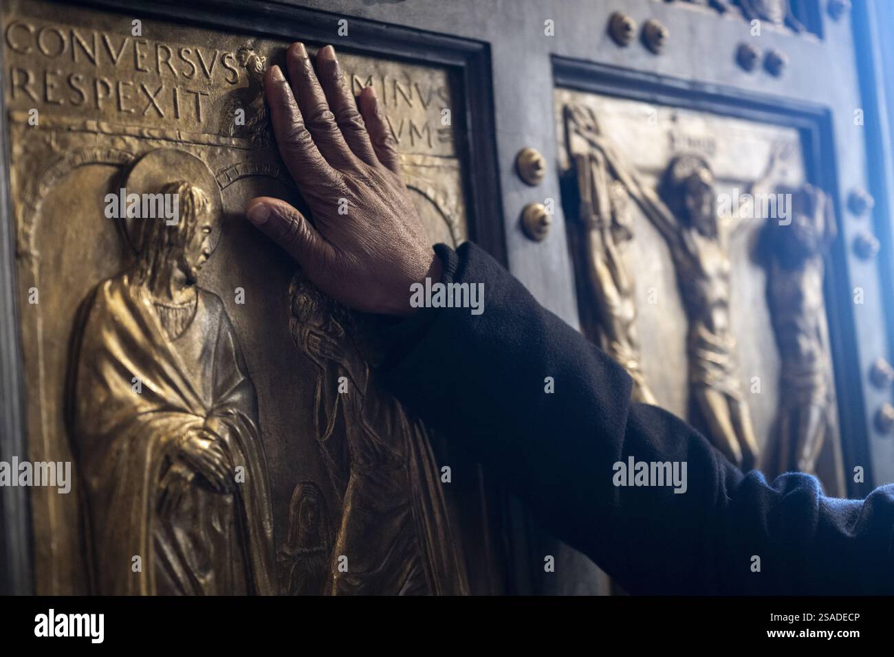 Pilgrims pass through the Holy Door of St. Peter's Basilica during the ...