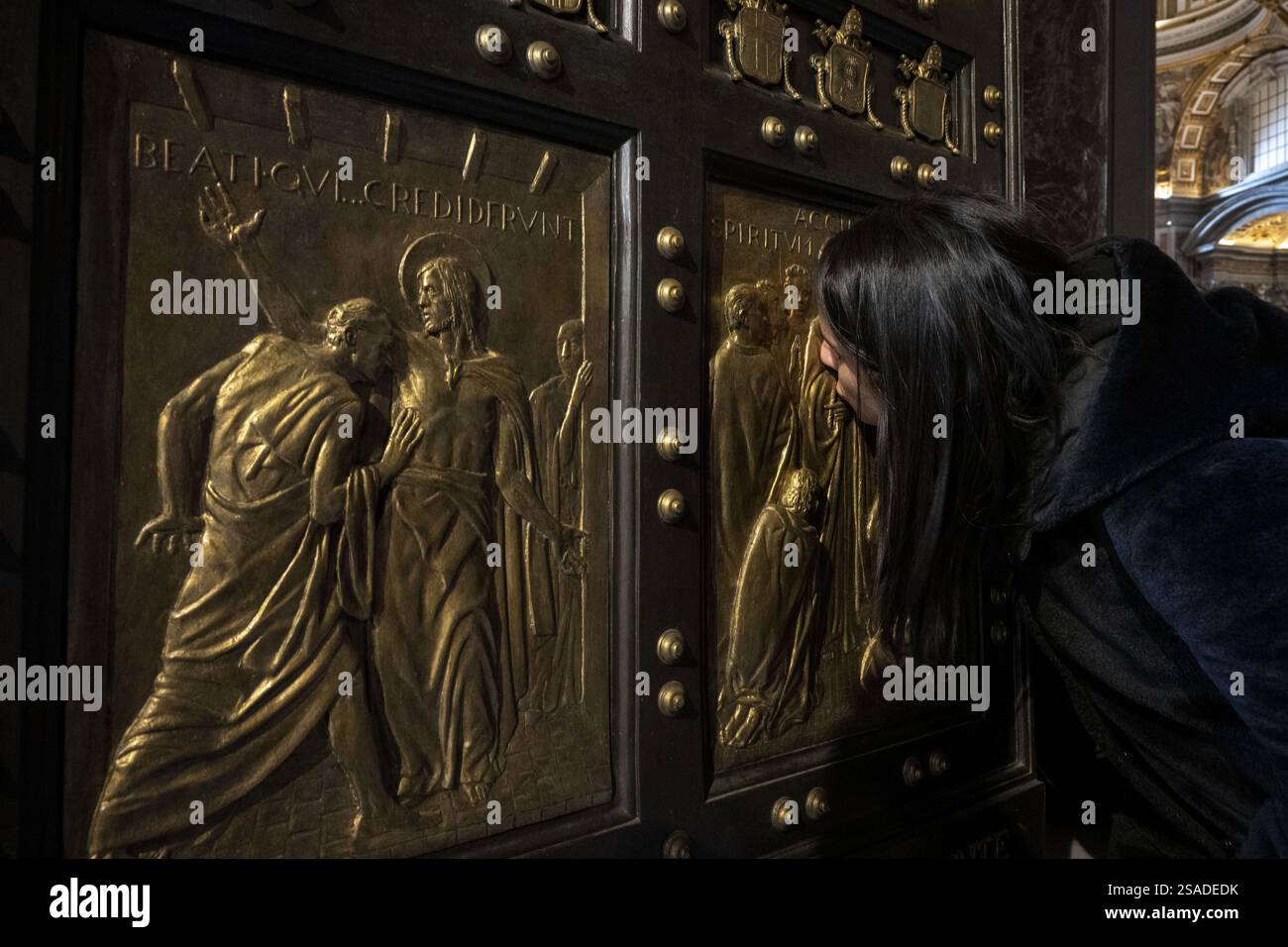 Pilgrims pass through the Holy Door of St. Peter's Basilica during the ...