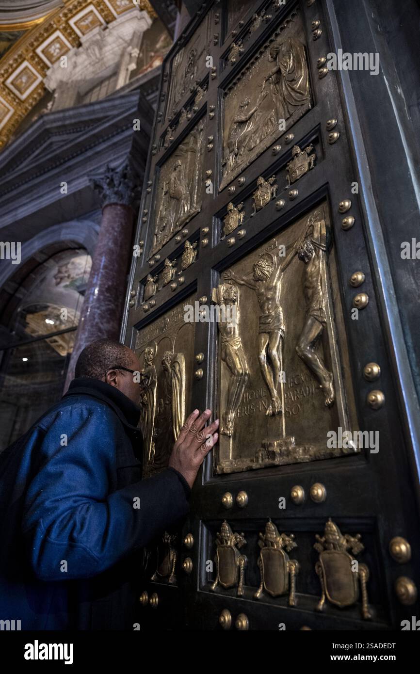 Pilgrims pass through the Holy Door of St. Peter's Basilica during the ...