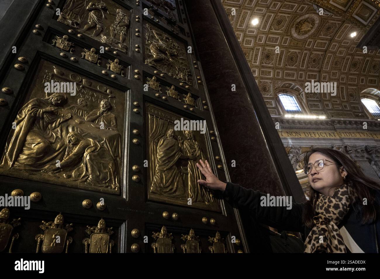 Pilgrims pass through the Holy Door of St. Peter's Basilica during the ...