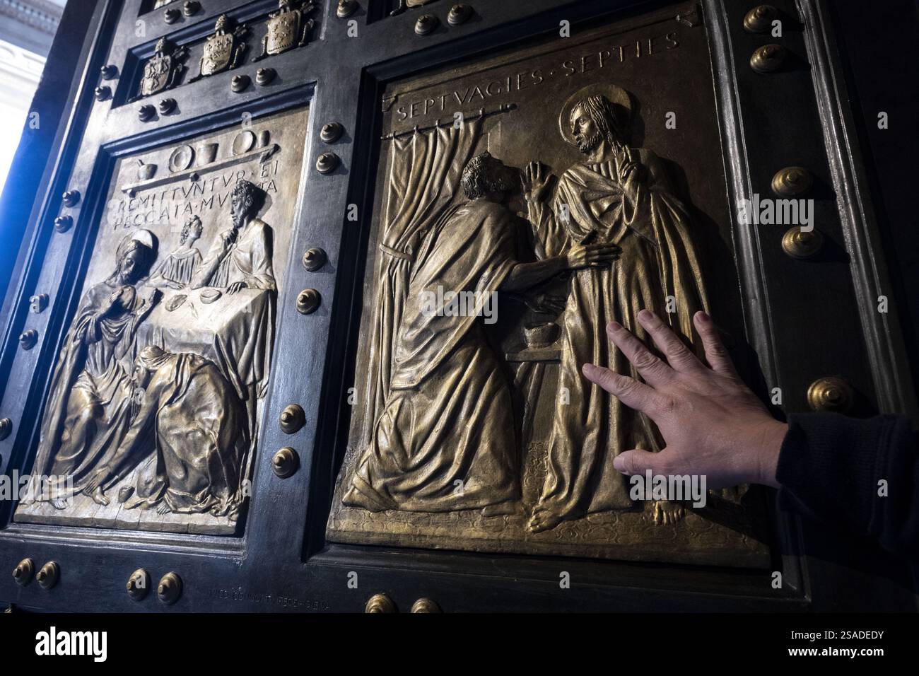 Pilgrims pass through the Holy Door of St. Peter's Basilica during the ...