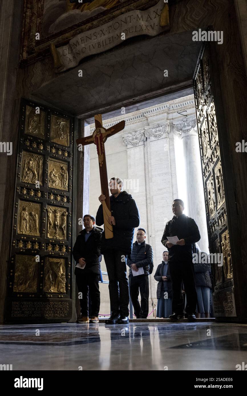 Pilgrims pass through the Holy Door of St. Peter's Basilica during the ...