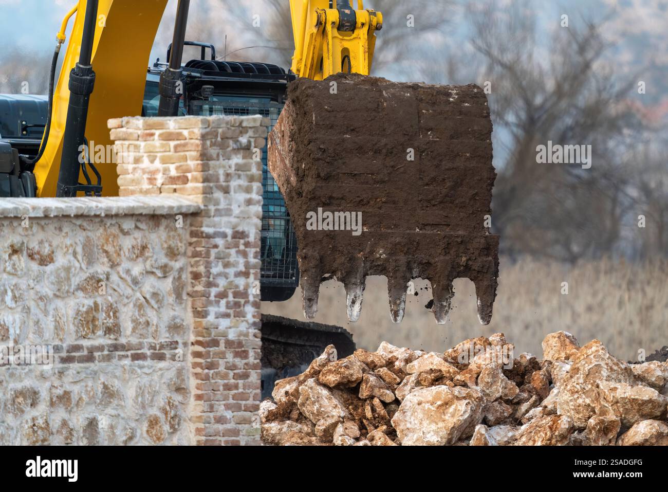 Excavator digging stone loading truck hi-res stock photography and ...