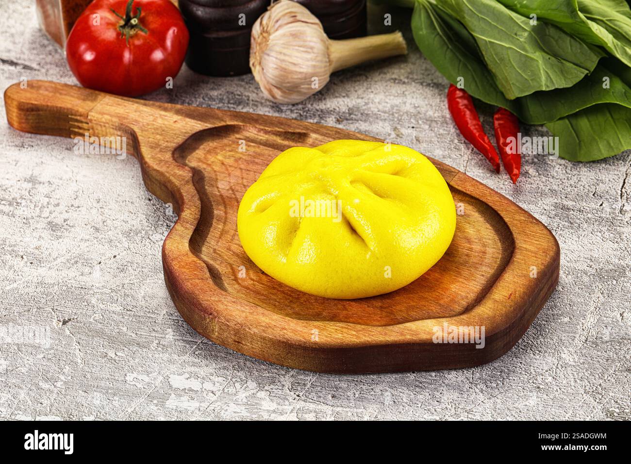 Asian stuffed steamed yellow Bun Bao Stock Photo - Alamy