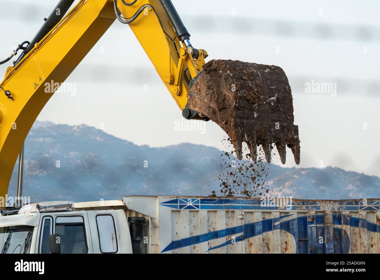 Large digger loading a lorry Stock Photo - Alamy