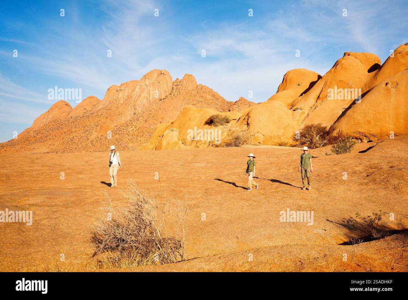 Family mother and two kids hiking in Spitzkoppe area in Damaraland ...