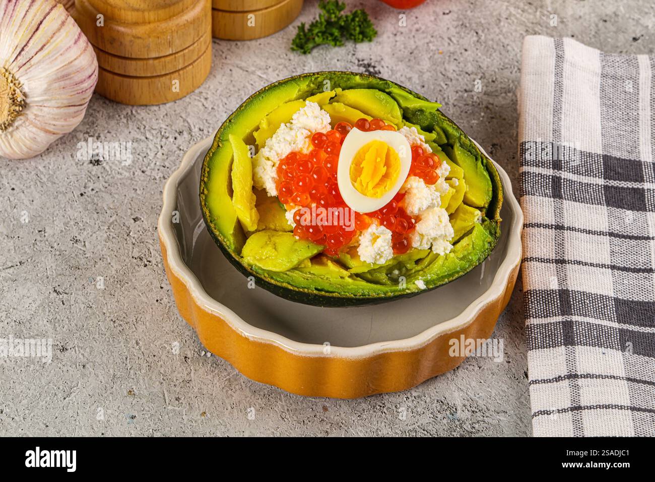 Avocado with red caviar and quil egg and soft cheese Stock Photo - Alamy