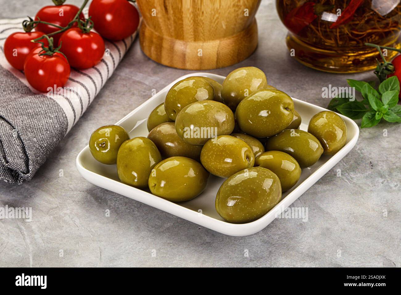 Big ripe green marinated olives in the bowl Stock Photo - Alamy