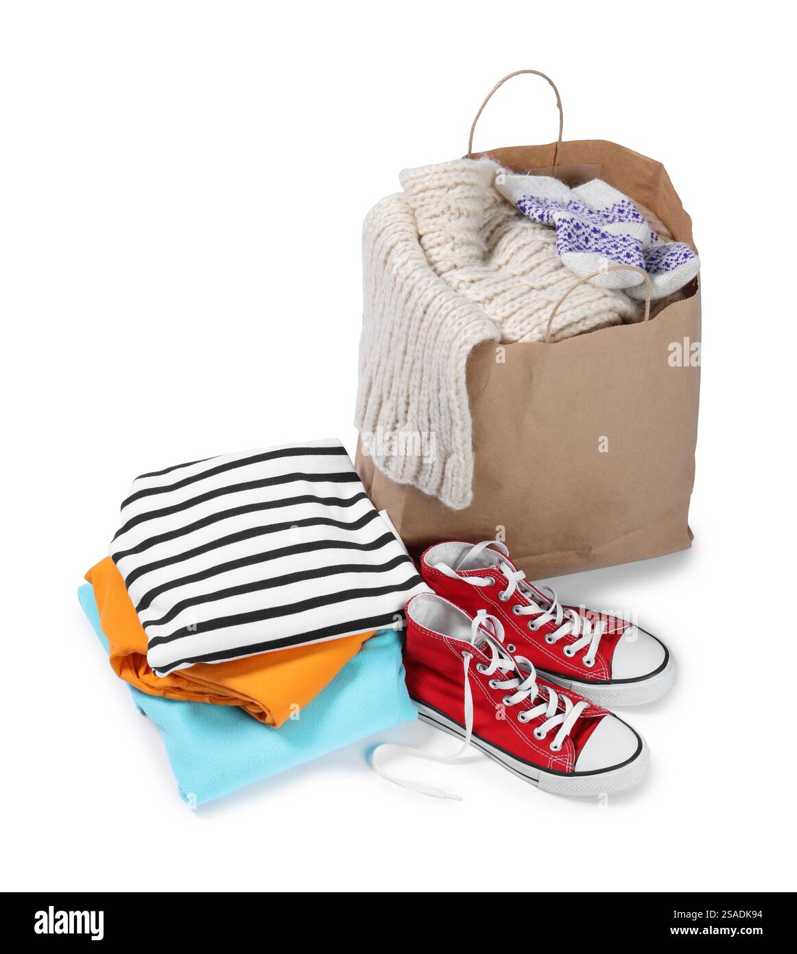 Bag with used clothes and sneakers isolated on white Stock Photo - Alamy