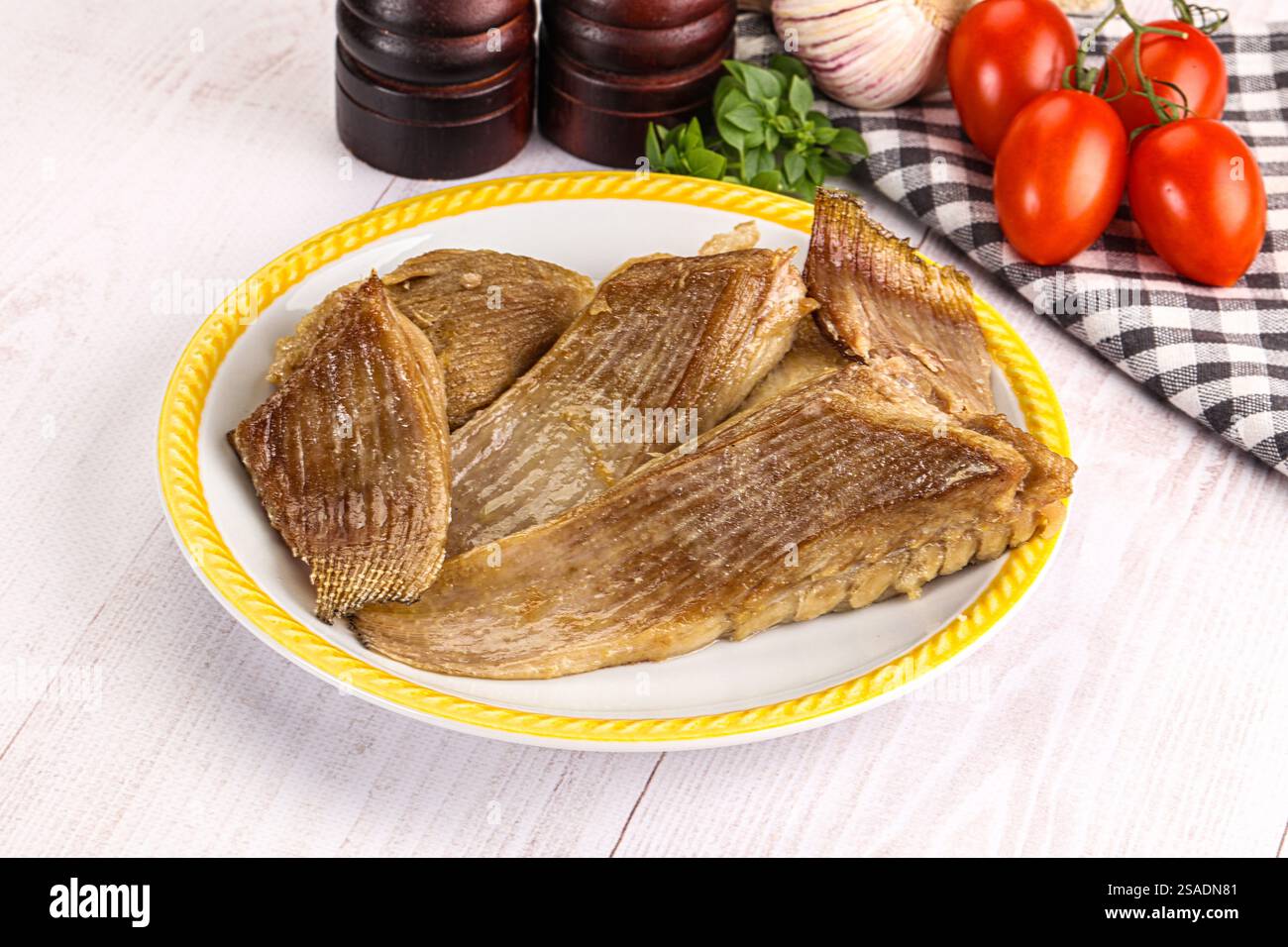 Baked stingray witngs with oil and spices Stock Photo - Alamy