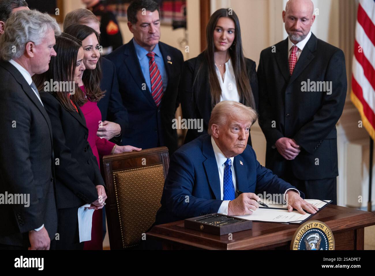 US President Donald Trump signs the Laken Riley Act in the East Room of ...