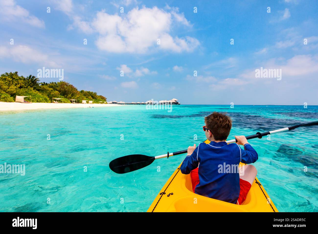 Back view of happy teenage boy on a kayak at tropical lagoon Stock ...