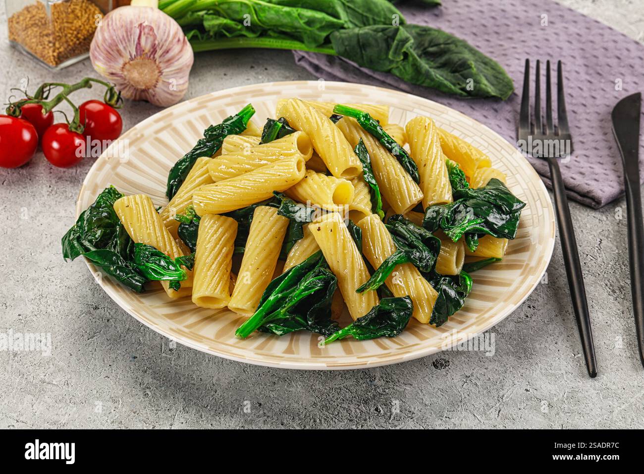 Italian cuisine - pasta tortiglioni with spinach Stock Photo - Alamy
