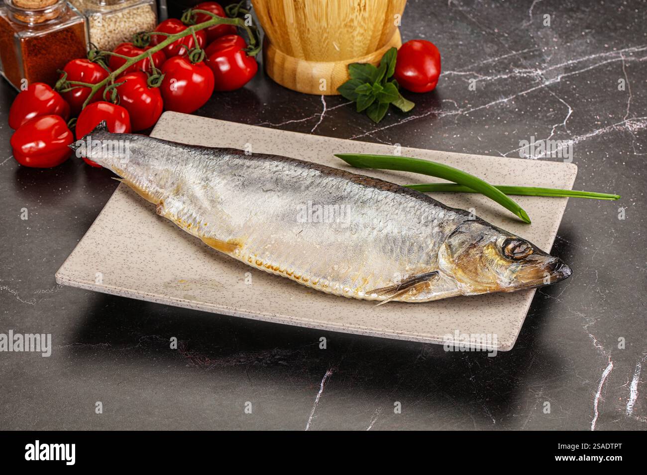 Whole raw salted herring fish in the plate Stock Photo - Alamy