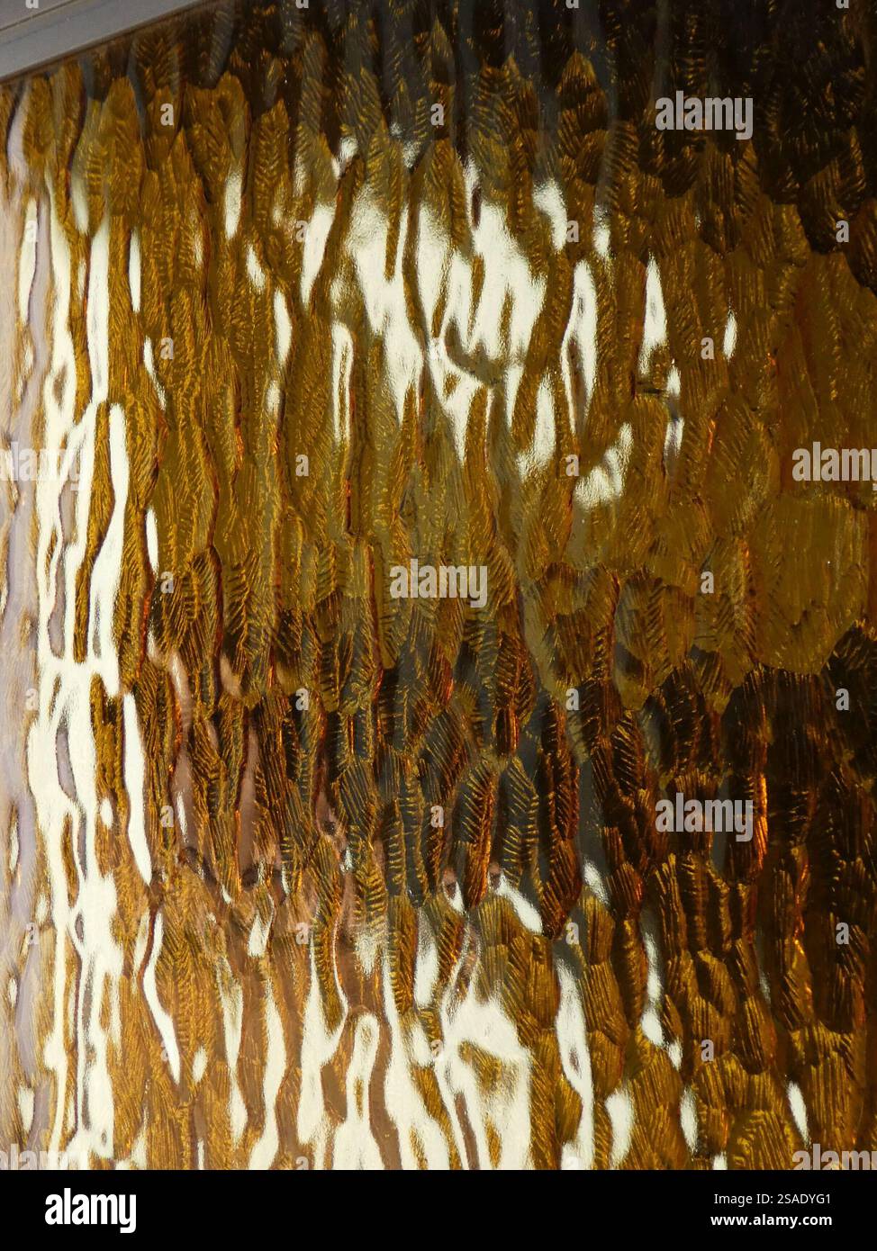 Window panes of textured glass in the afternoon light, a closeup view ...