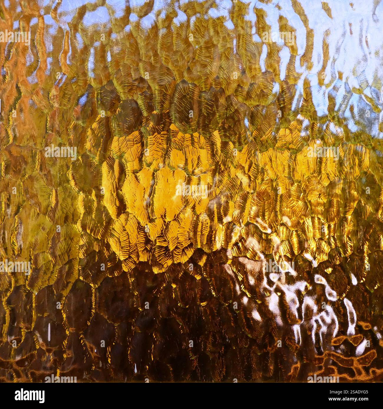 Window panes of textured glass in the afternoon light, a closeup view ...