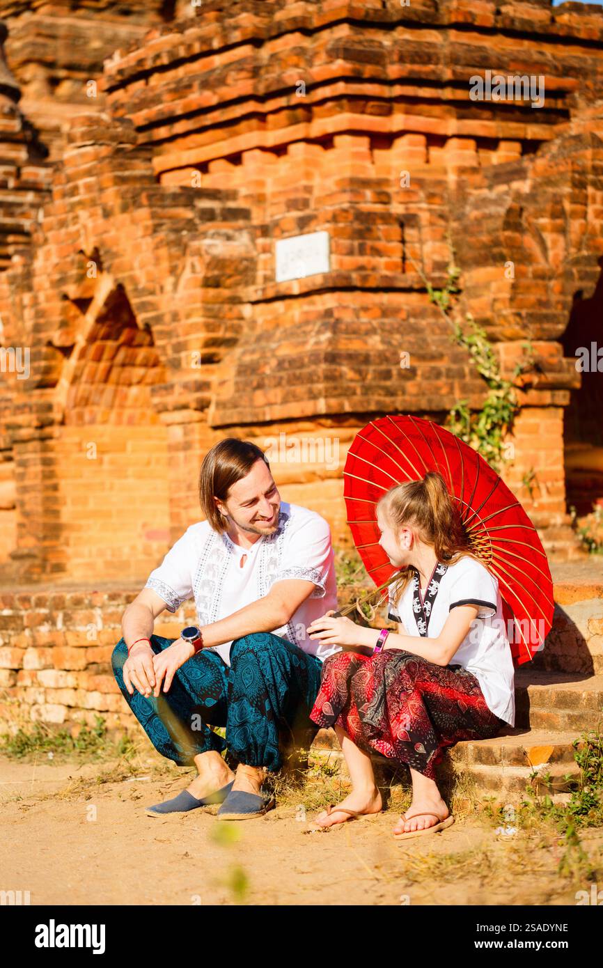 Family of father and daughter visiting ancient temples in Bagan ...