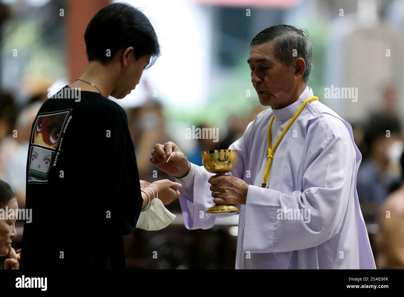 Tan Hoa Church. Sunday catholic mass. Priest giving holy communion. Ho ...