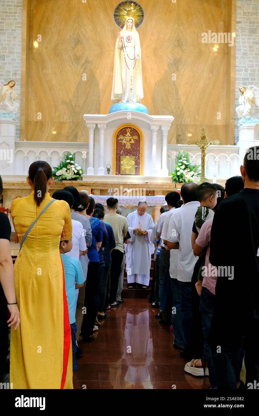 Catholic church of Fatima. Catholic mass. Priest giving holy communion ...