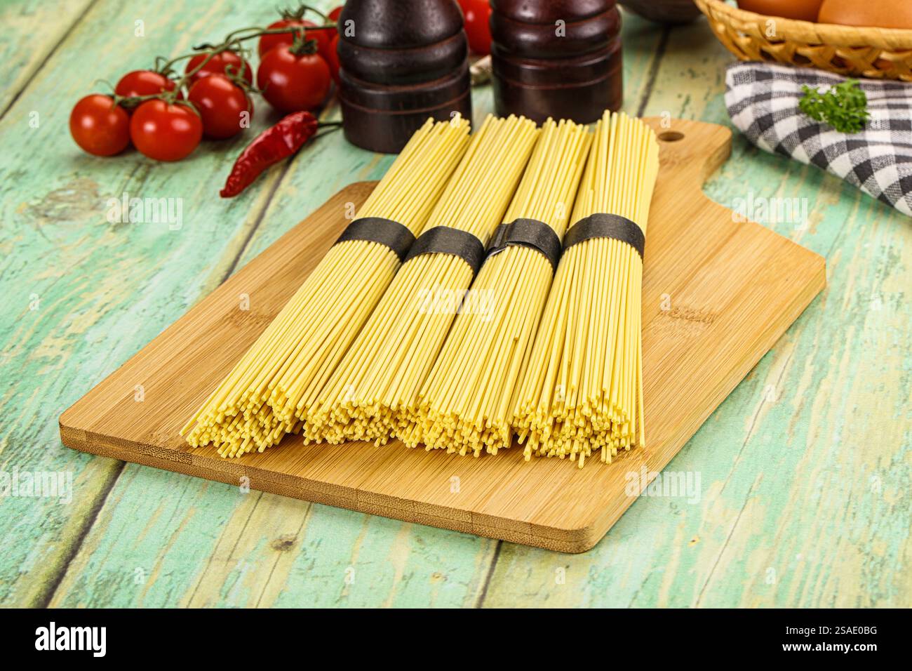 Raw dry uncooked yellow egg noodles Stock Photo - Alamy