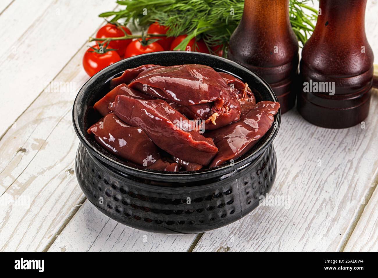 Raw chicken liver uncooked in the bowl with spices Stock Photo - Alamy