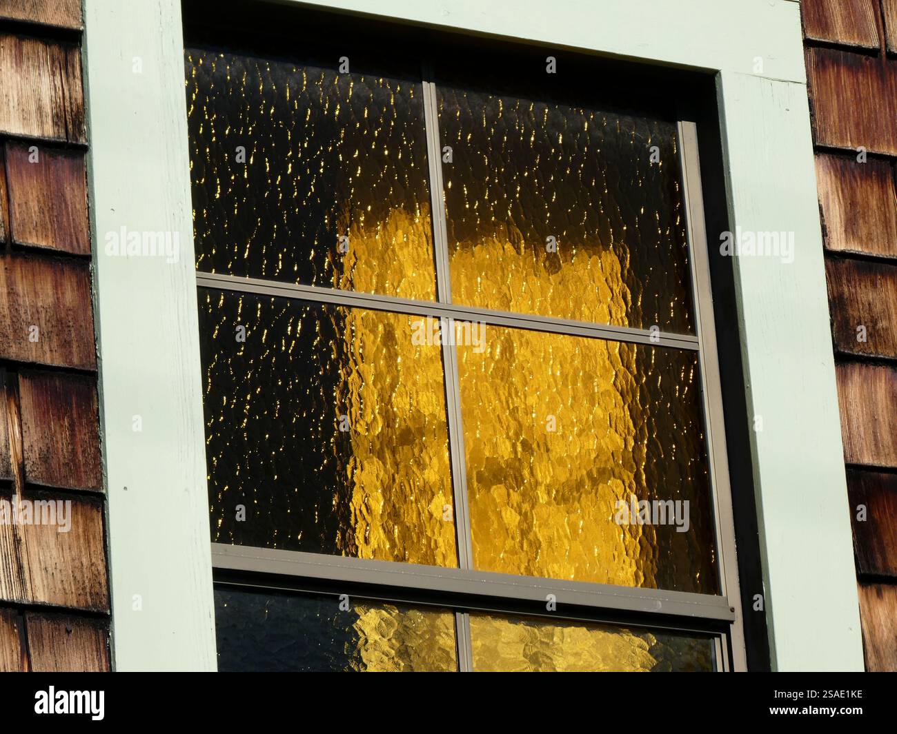 Objects behind ornate windows with golden textured glass panes in the ...