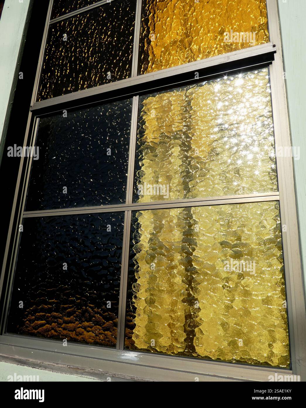 Objects behind ornate windows with golden textured glass panes in the ...
