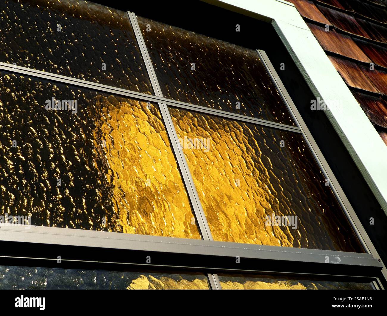 Objects behind ornate windows with golden textured glass panes in the ...