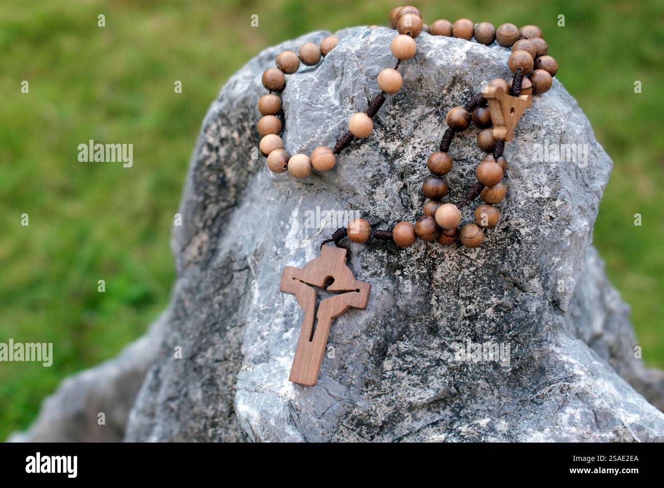 Rosary on a rock. Symbol of strength and eternity. Catholic church ...