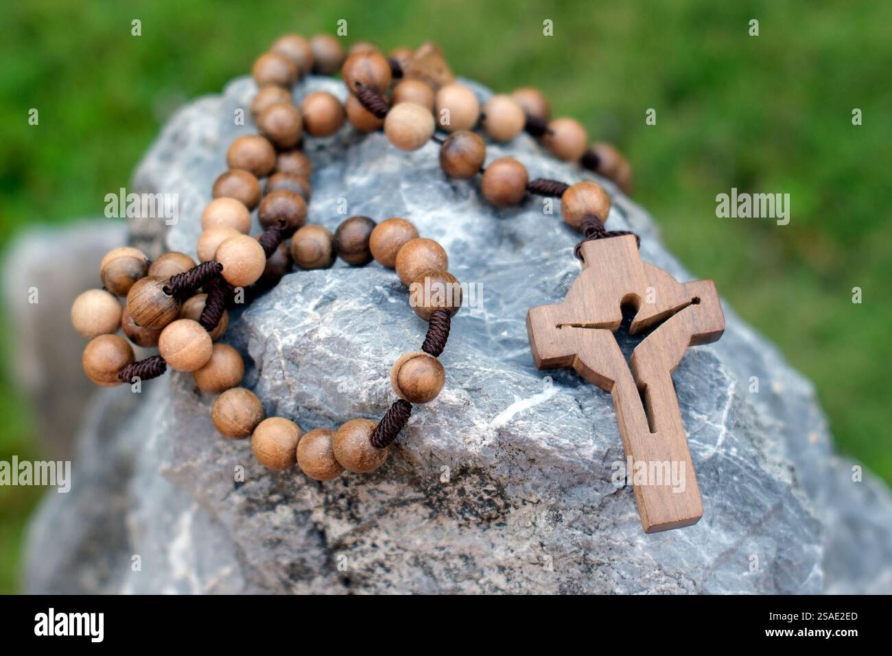 Rosary on a rock. Symbol of strength and eternity. Catholic church ...