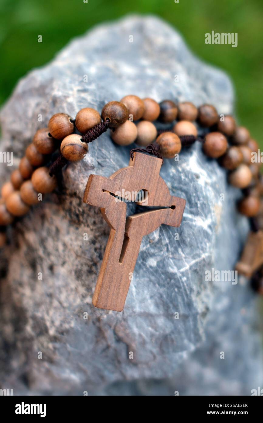 Rosary on a rock. Symbol of strength and eternity. Catholic church ...