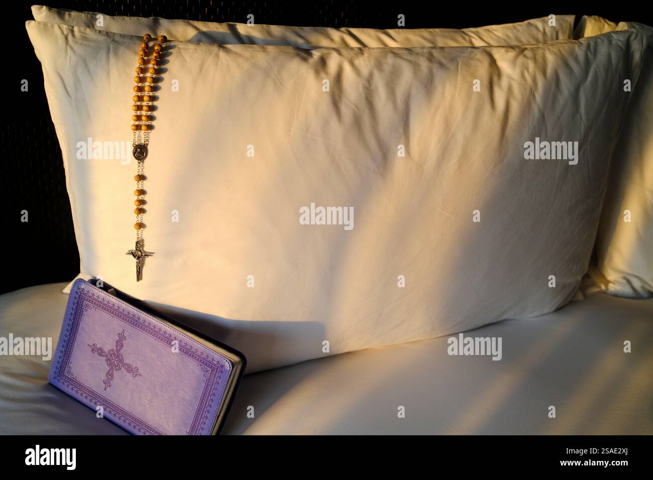 Pray at home. Bible and Rosary on a bed Stock Photo - Alamy