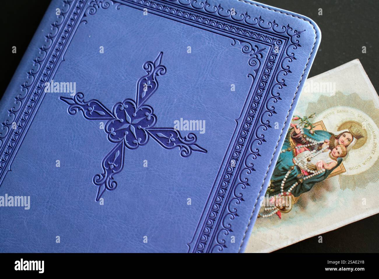 Blue Bible with a religious image. Virgin Mary and child Stock Photo ...