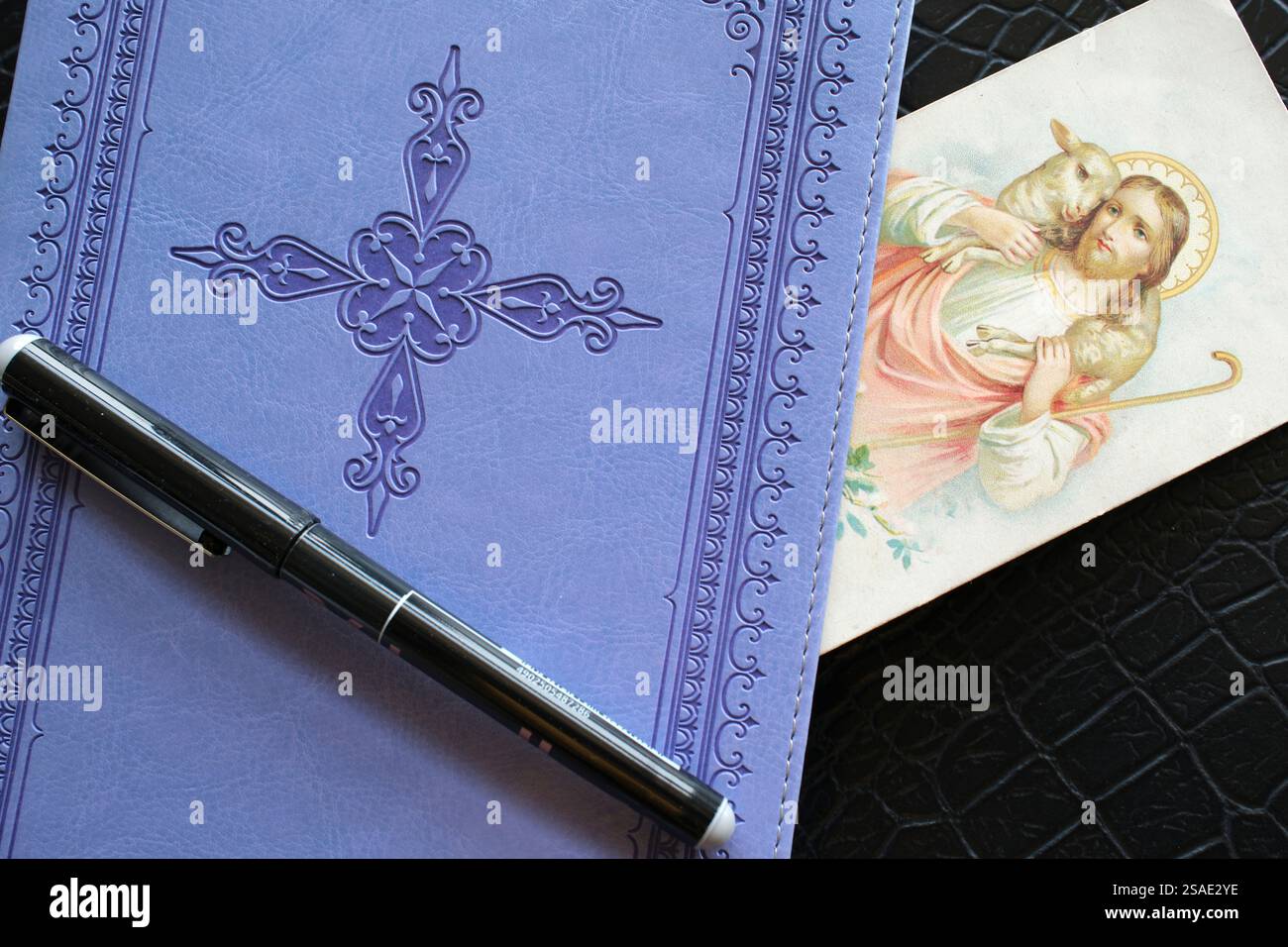 Blue Bible with a religious image. Jesus the good shepherd Stock Photo ...