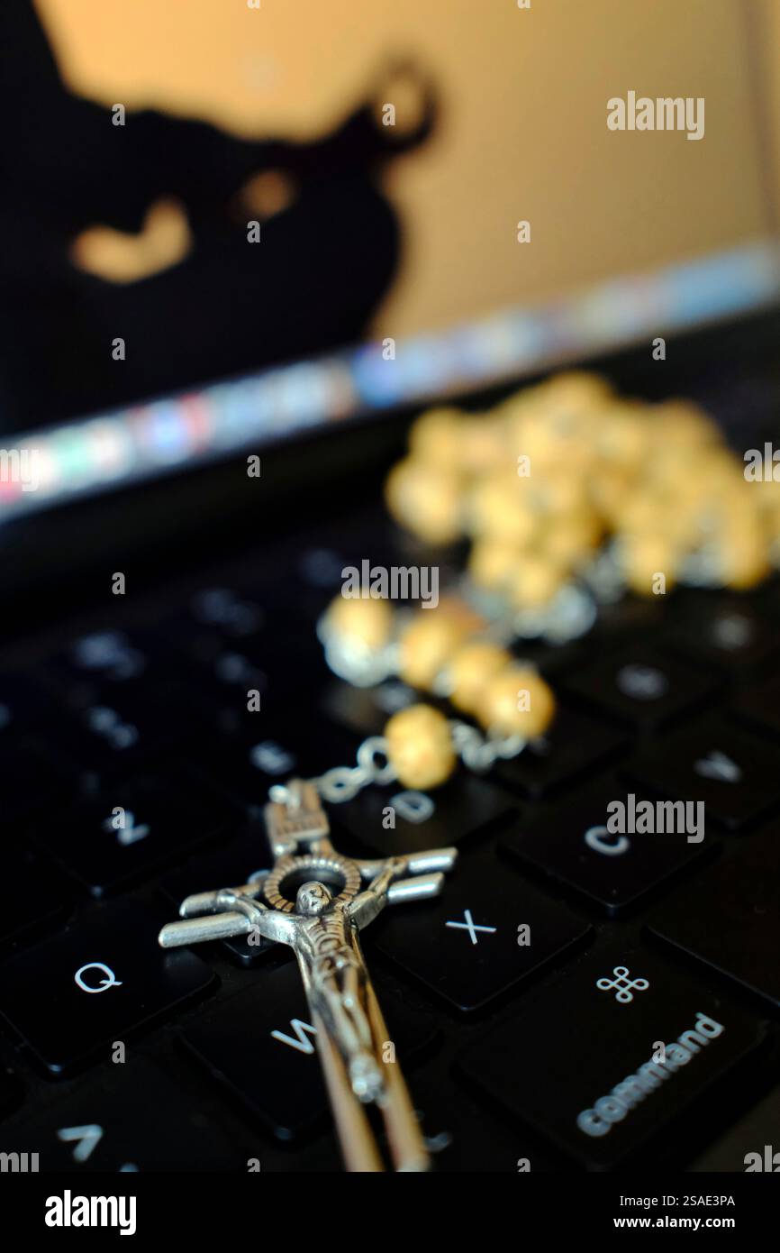 Catholic rosary beads on a laptop keyboard Stock Photo - Alamy
