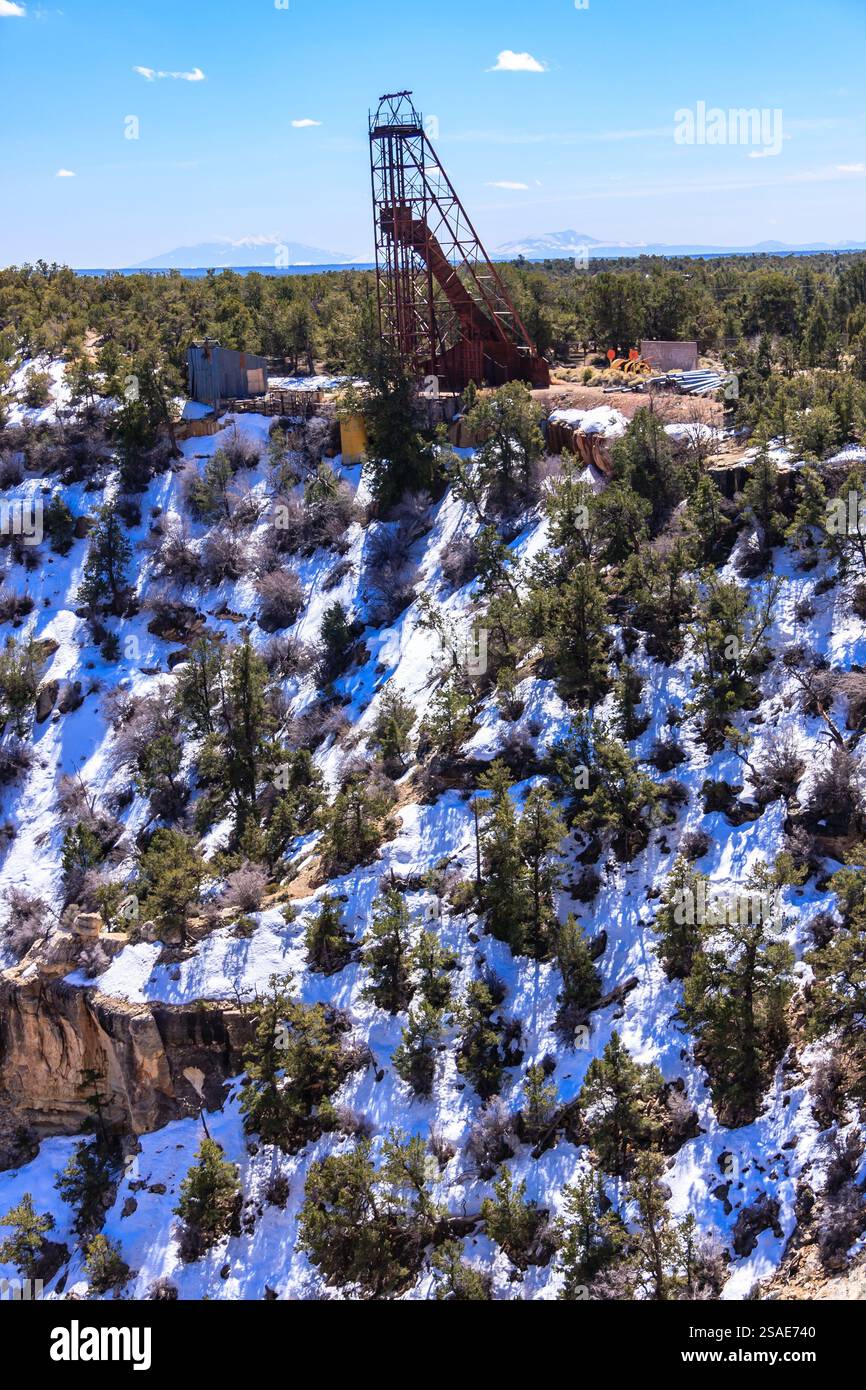 A large crane is on top of a mountain. The crane is red and is ...