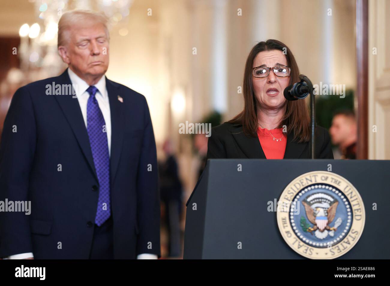 United States President Donald Trump listens as Allyson Phillips ...