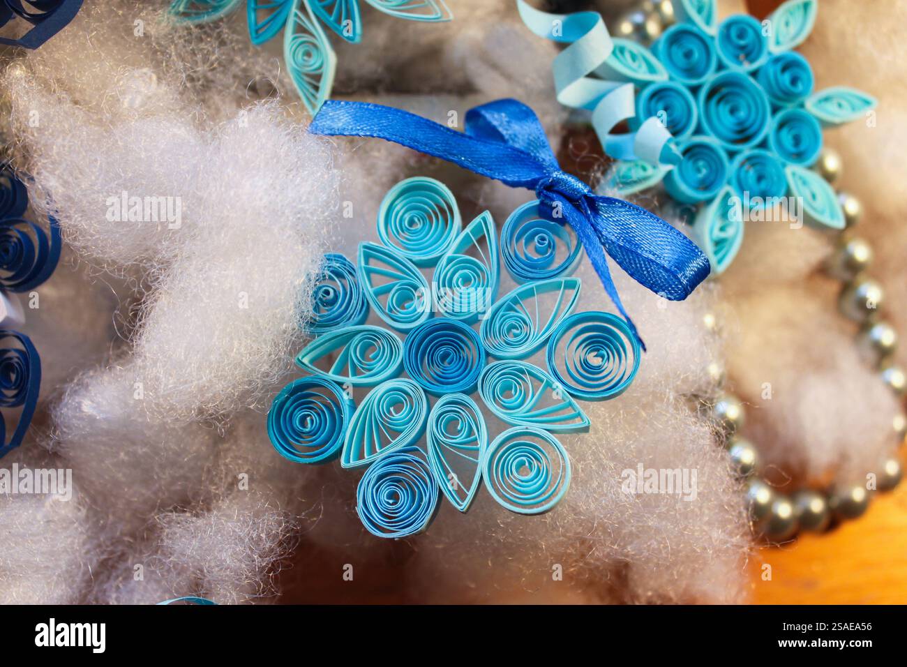 DIY paper crafts, snowflakes made using quilling technique lie ...
