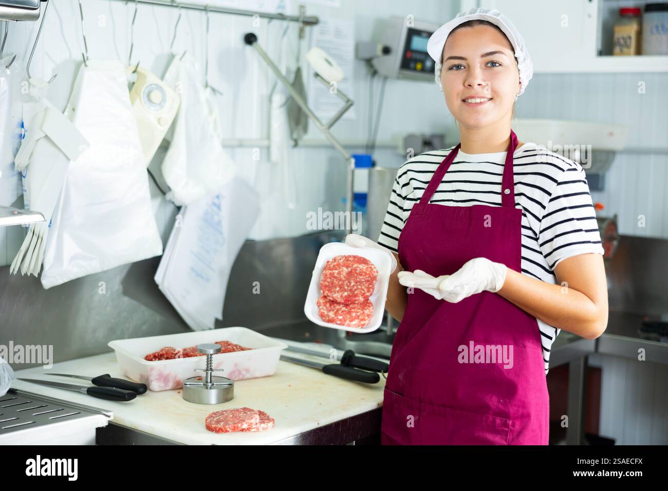 Cooking semi finished products - woman shows meat cutlets using special ...