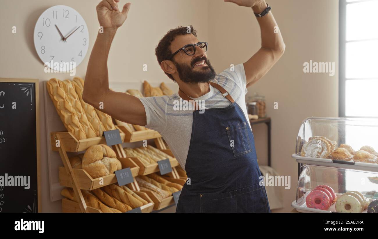 Young hispanic man with beard and glasses wearing apron joyfully ...