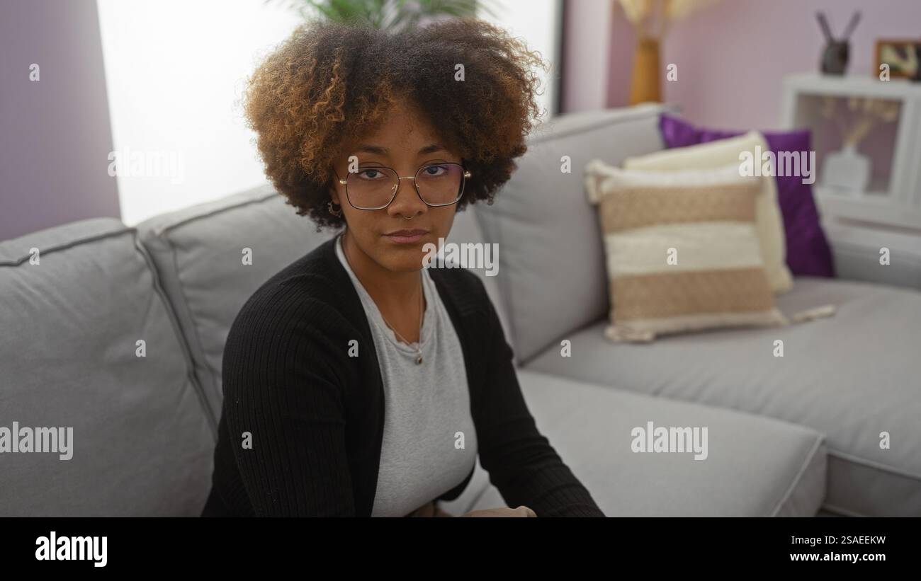 Woman sitting comfortably on a couch in a cozy living room with soft ...