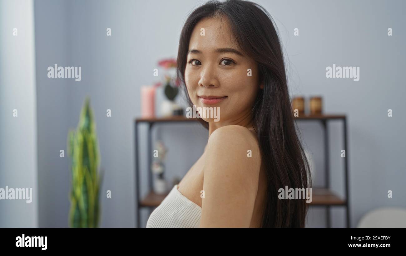 Beautiful chinese woman in a wellness spa with serene indoor ambiance and subtle decorations ...