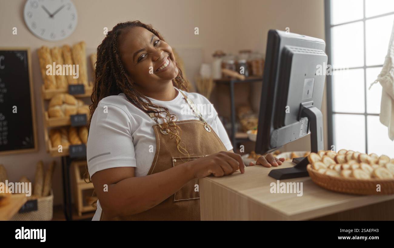 Plus size woman smiling while working at a bakery counter, surrounded ...